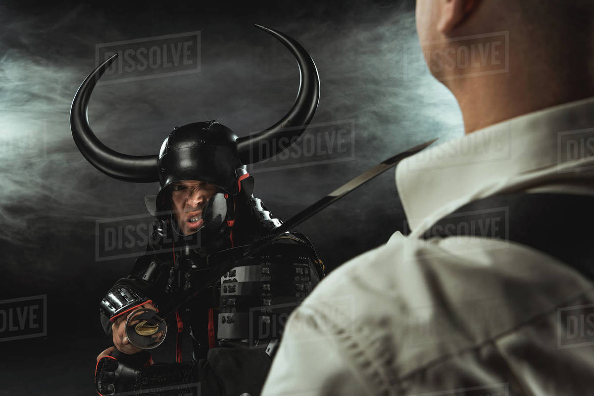 Angry samurai with katana ready to kill modern man - Stock Photo - Dissolve