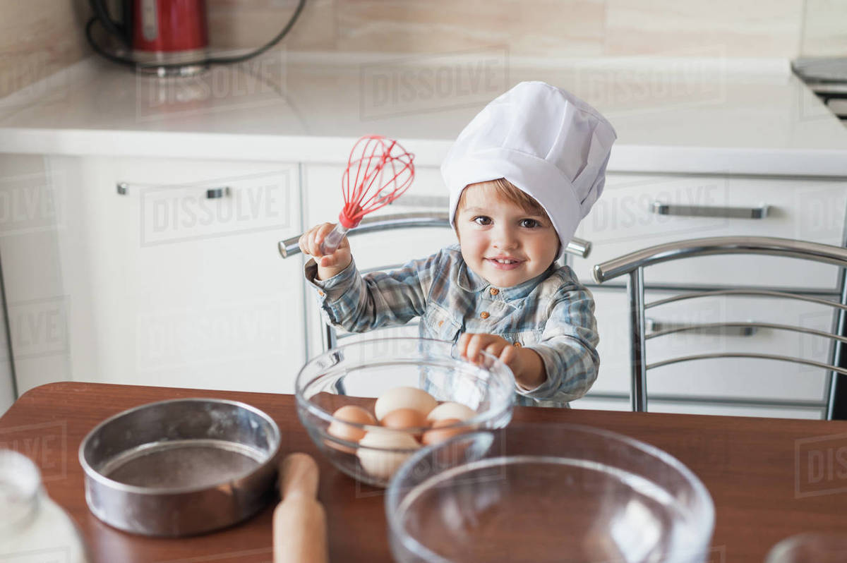adorable little kid in chef hat with whisk and eggs - Royalty-free ...