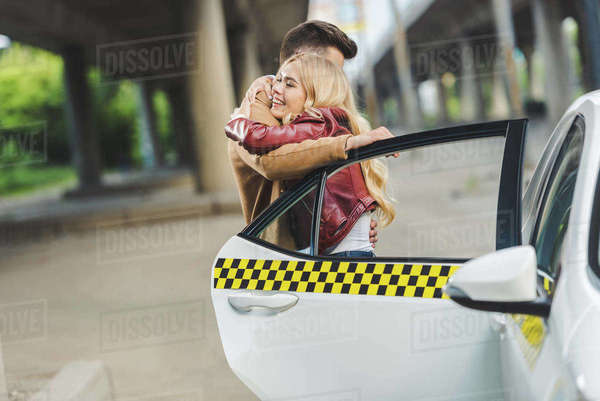 Beautiful young couple hugging near taxi cab - Royalty-free Stock Photo ...