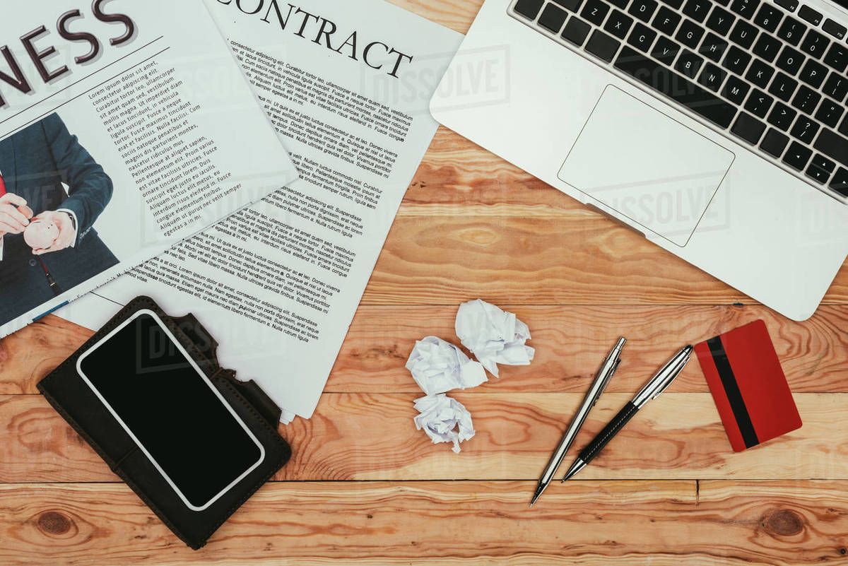 Top view of smartphone with blank screen, contract newspaper, laptop ...