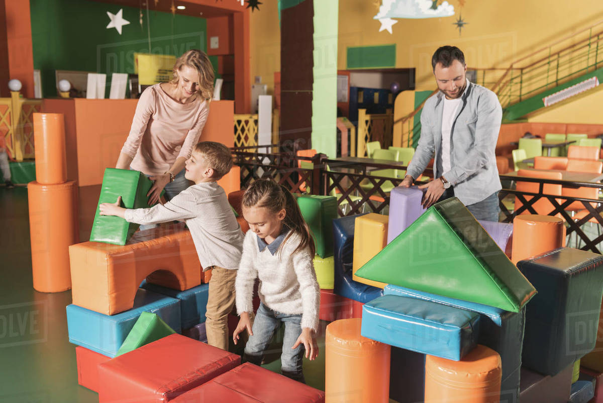 happy family with two children playing with colorful blocks in game ...