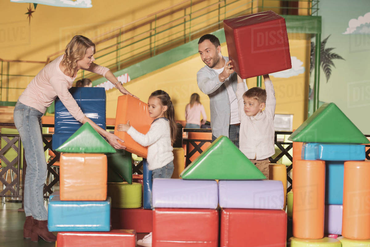 happy family building castle with colorful blocks at entertainment ...