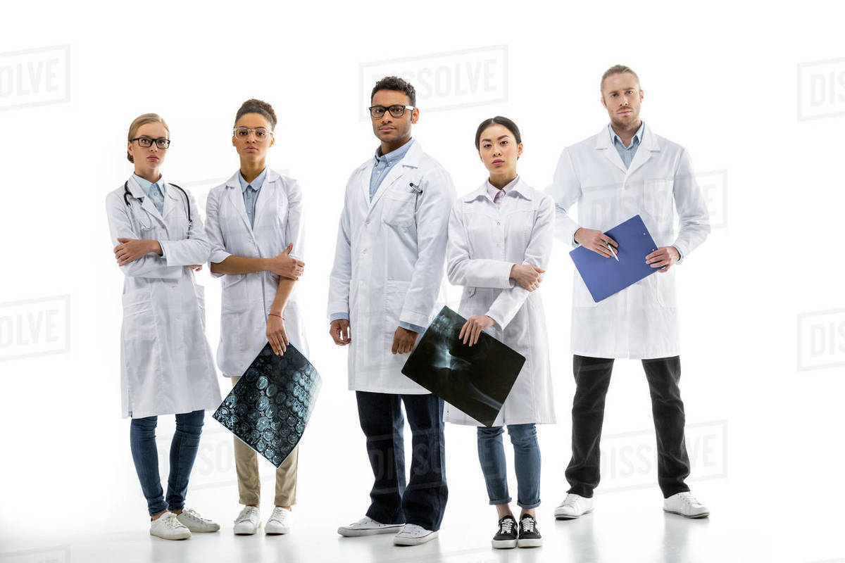 Team of young professional doctors standing together isolated on white ...