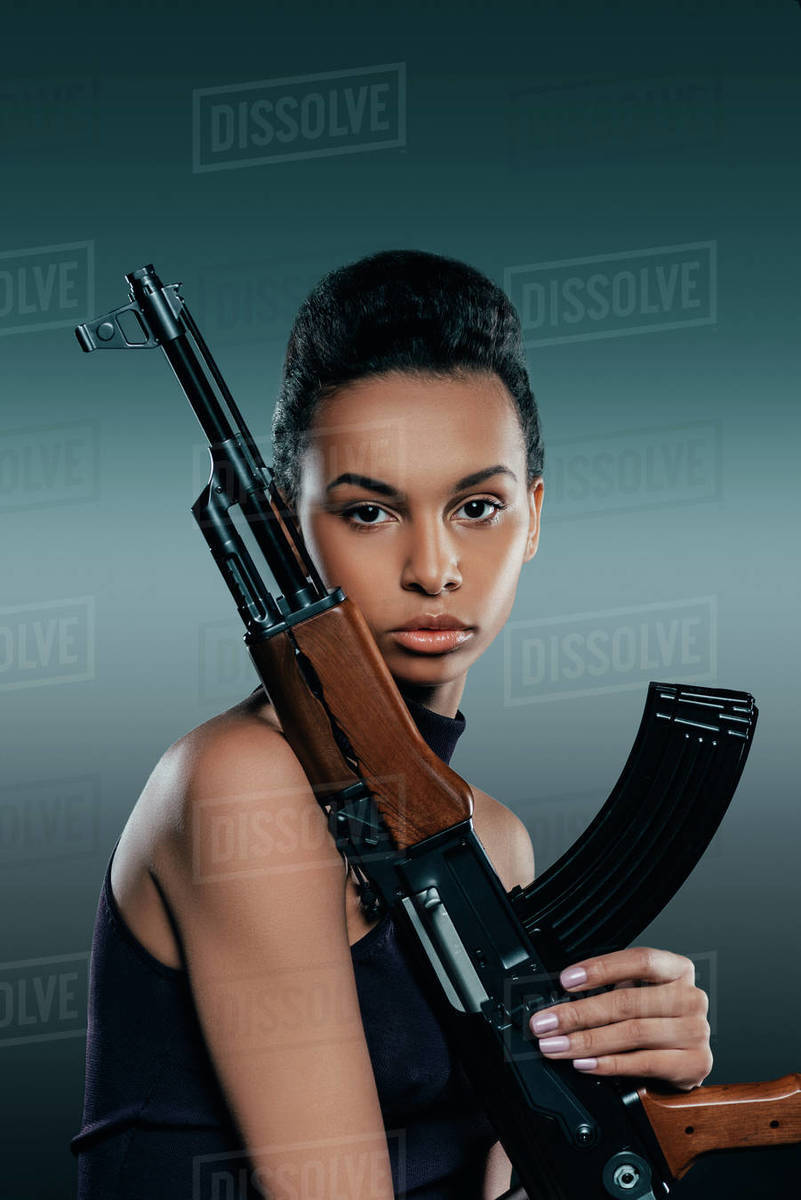 Attractive fashionable african american girl posing with rifle ...