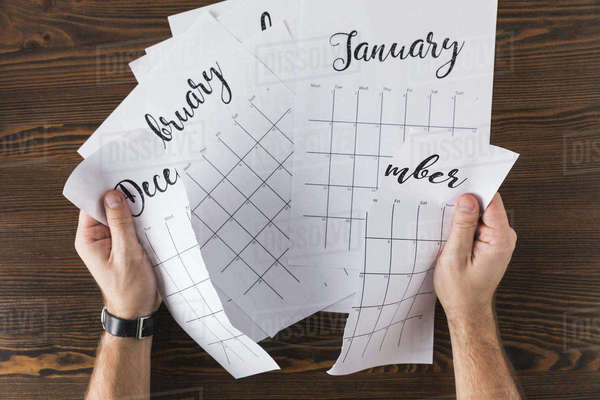 Cropped shot of man tearing calendar on wooden tabletop - Royalty-free ...