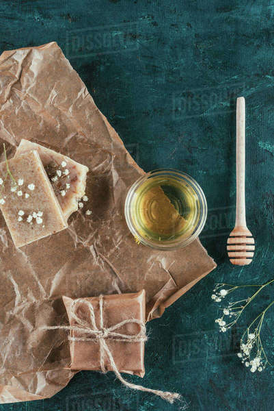 Flat lay with natural homemade soap and oil for spa on crumpled paper ...