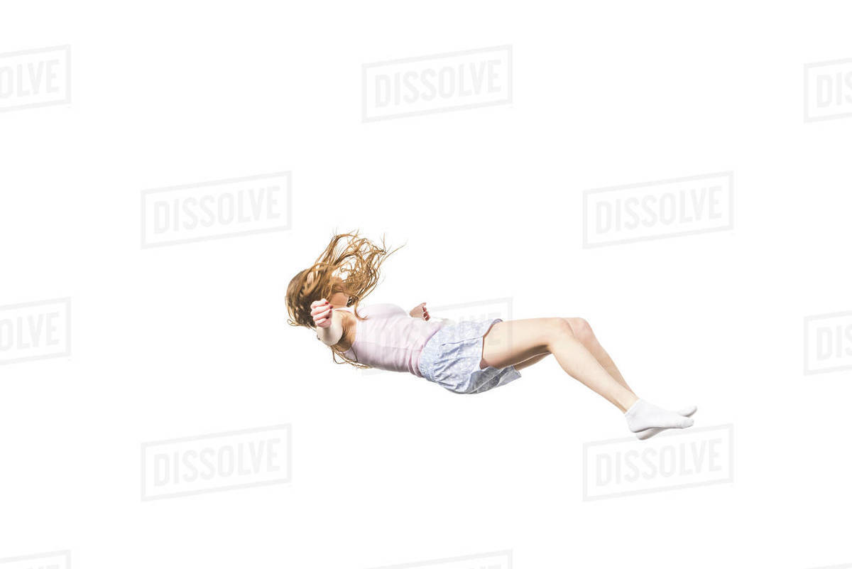Full length view of young woman falling isolated on white - Stock Photo ...