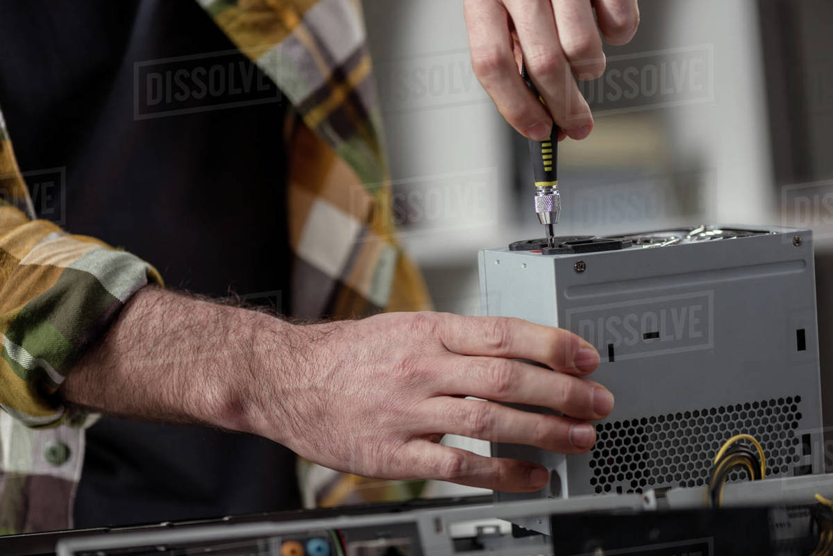 man using screwdriver while fixing computer detail - Royalty-free Stock ...