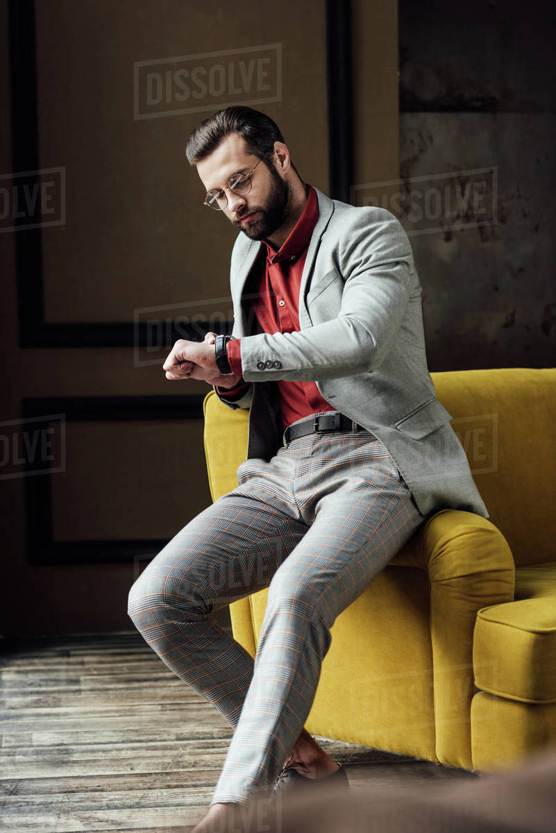 Handsome bearded elegant man looking at watch - Royalty-free Stock ...