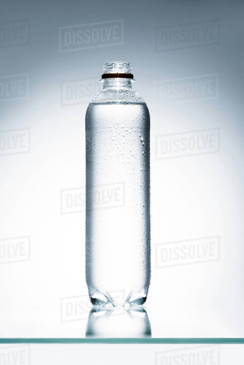 Plastic bottle full of water on reflective surface - Royalty-free Stock ...