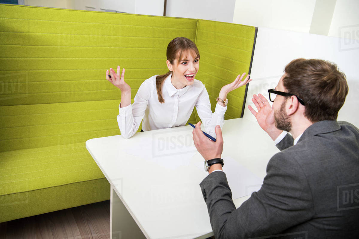 Two business colleagues having debate and sitting at table - Stock ...
