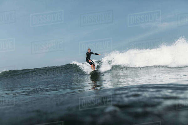 Surfer having fun and surfing wave on surf board in ocean - Royalty ...