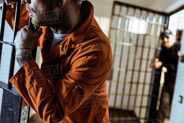 Cropped image of prisoner leaning on prison bars - Royalty-free Stock ...