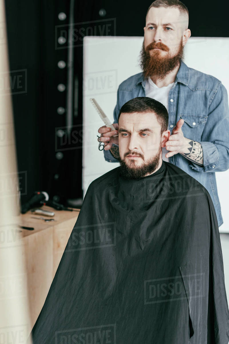 barber looking at client haircut in mirror at barbershop - Royalty-free ...