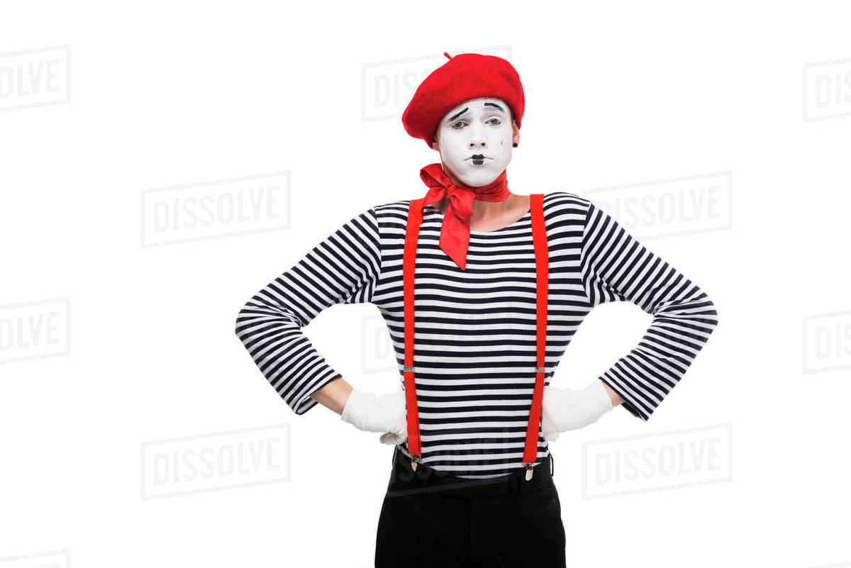 Grimacing mime standing with hands akimbo isolated on white - Royalty ...