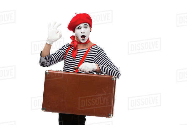 Mime holding brown suitcase and showing ok sign isolated on white ...