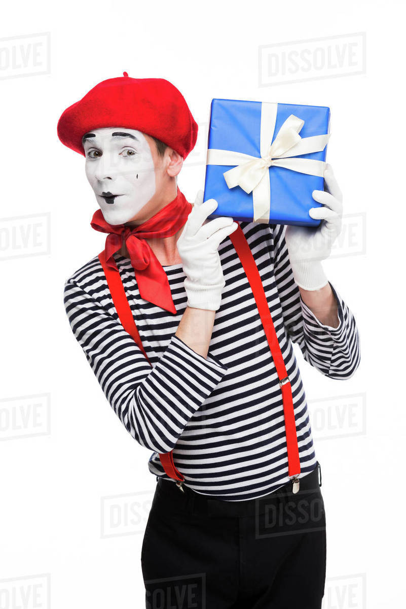 Cheerful mime holding gift box isolated on white - Stock Photo - Dissolve