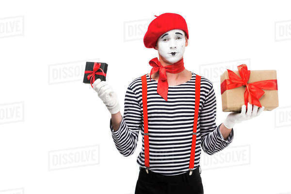 Mime holding present boxes and looking at camera isolated on white ...