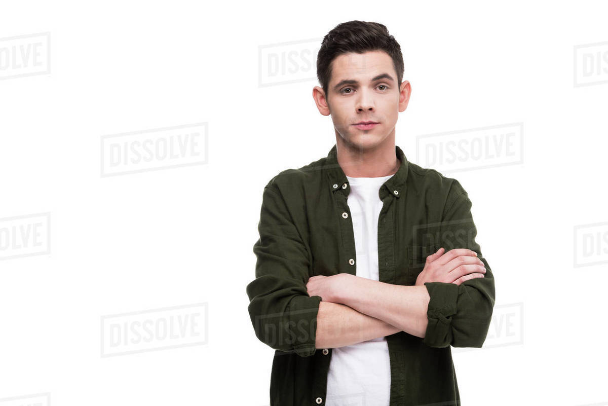 Man standing with crossed arms isolated on white - Stock Photo - Dissolve