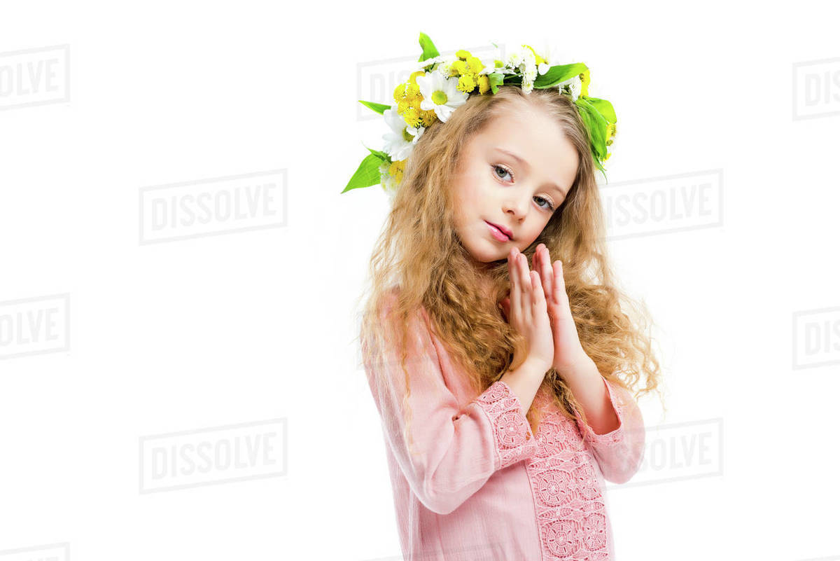 Little child holding handbreadths together and wearing wreath band from ...