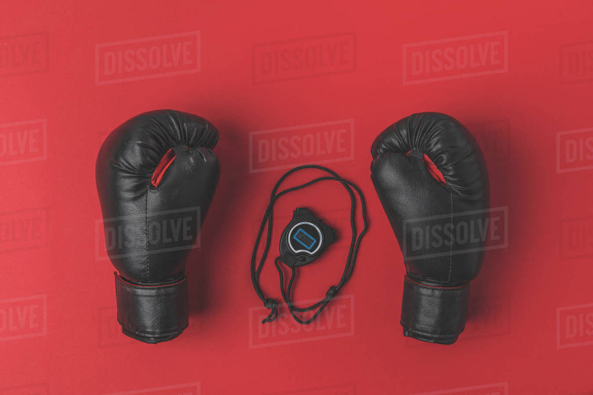 top view of boxing gloves with stopwatch on red tabletop - Stock Photo ...