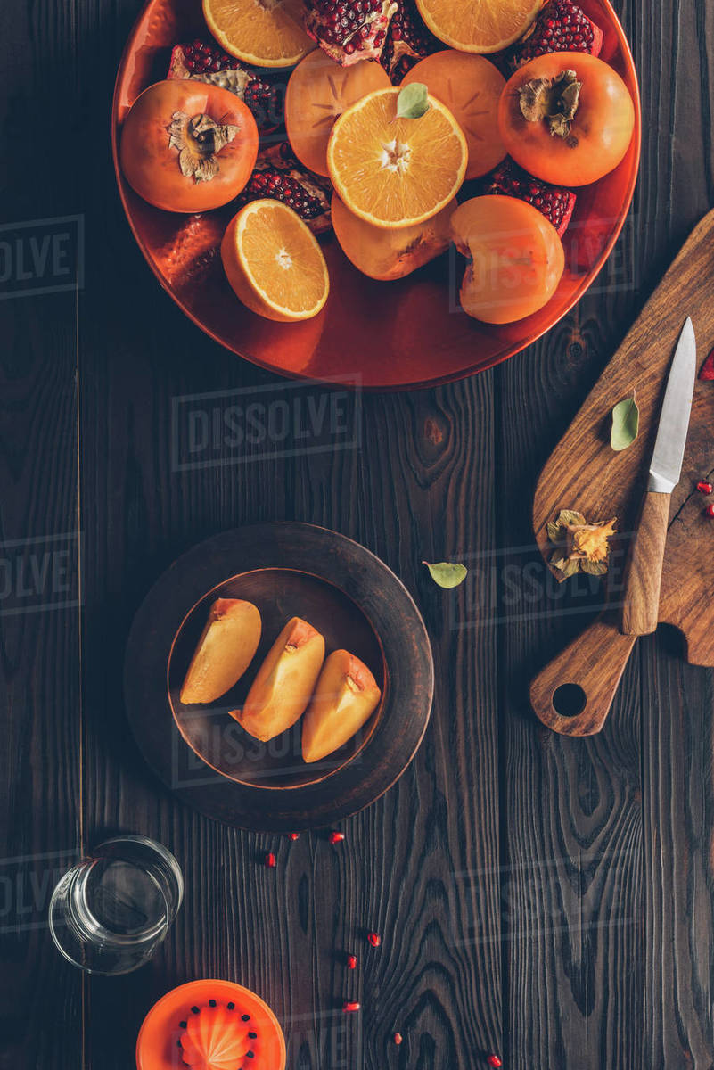 top view of fruits on plates on wooden table - Royalty-free Stock Photo ...