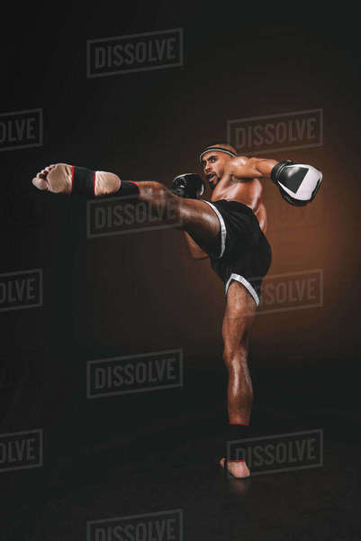 side view of muay thai fighter practicing kick, action sport concept ...