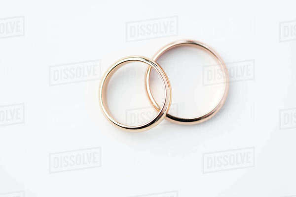 two golden wedding rings isolated on white, wedding rings background ...