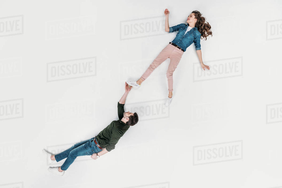 Top view of handsome man carrying his girlfriend with one hand isolated ...