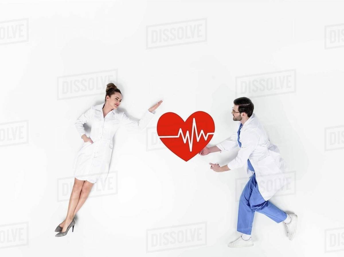 Creative collage of male and female doctors with heartbeat sign on ...