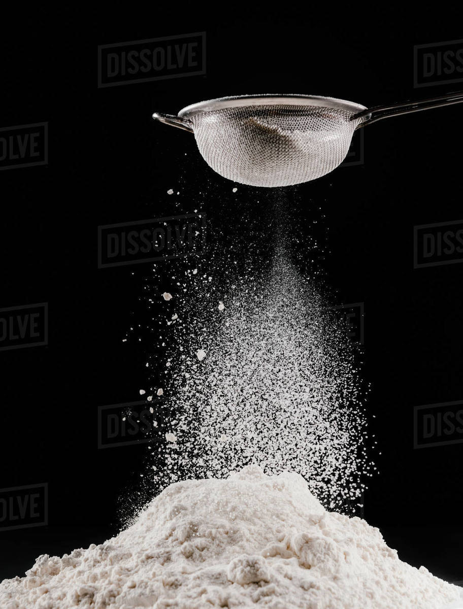 Flour falling from sieve on pile isolated on black - Royalty-free Stock ...