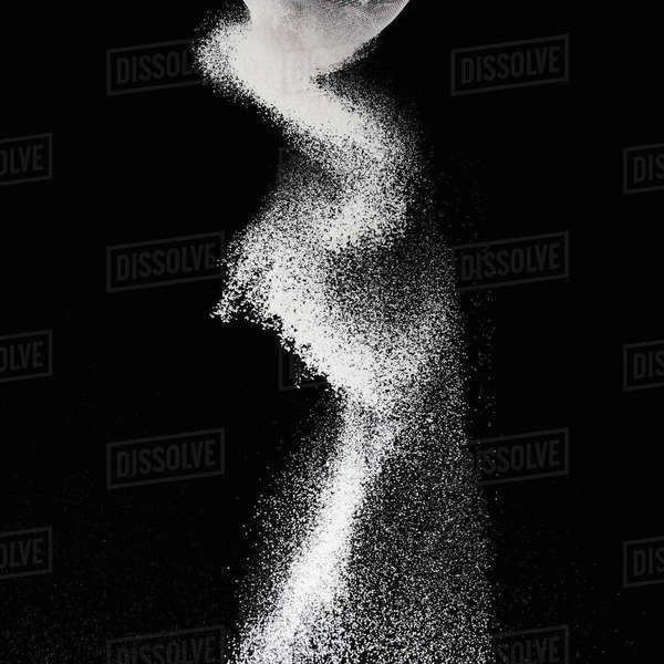 Sieve with falling flour isolated on black - Stock Photo - Dissolve