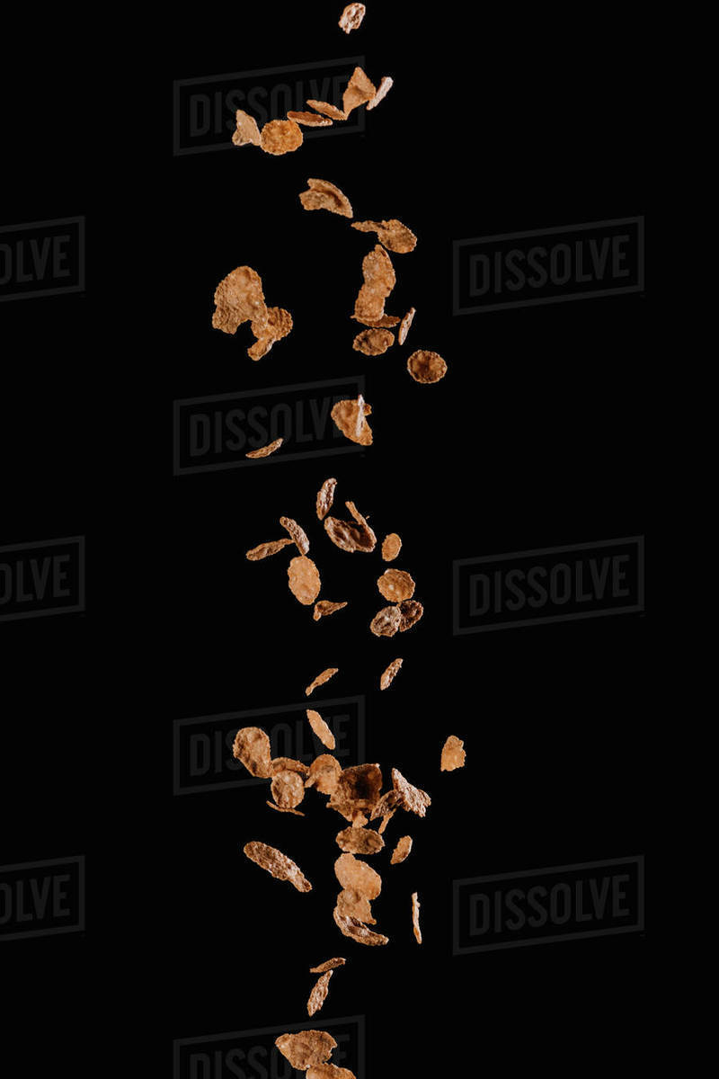 Falling yummy cornflakes isolated on black - Royalty-free Stock Photo ...