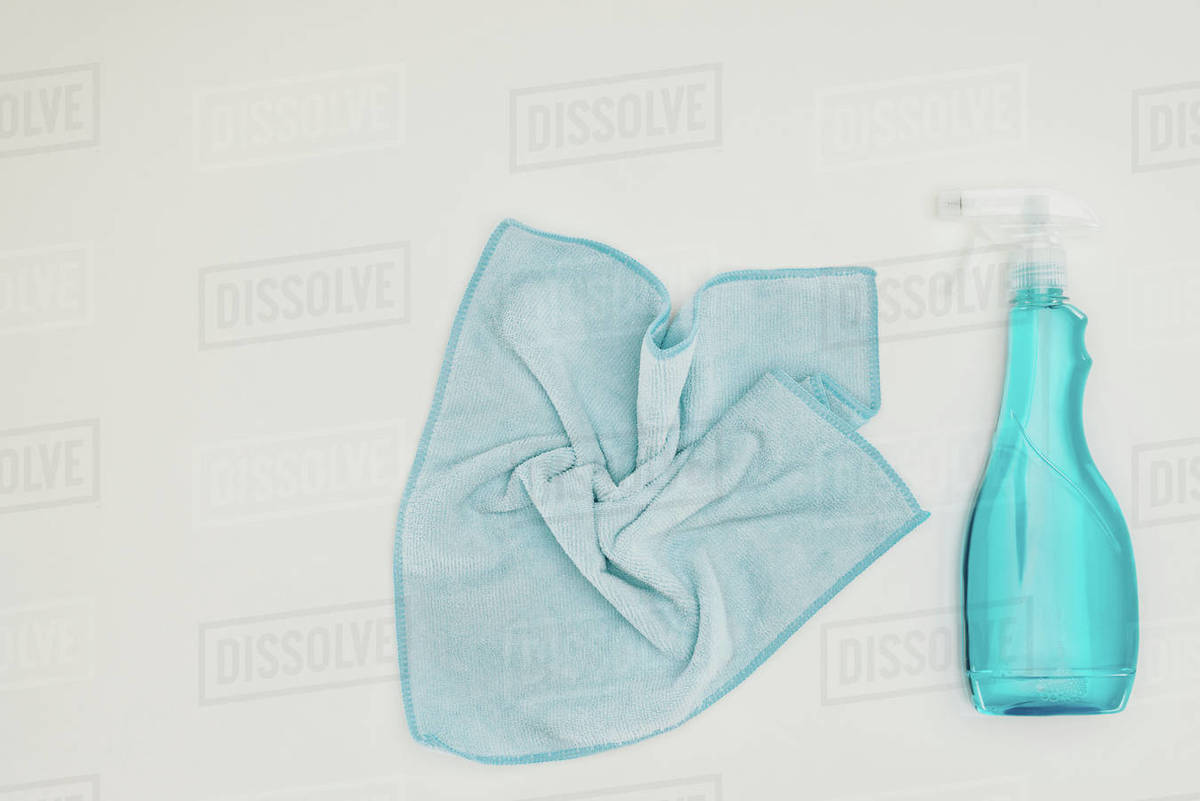 Top view of blue rag and spray bottle isolated on white - Royalty-free ...