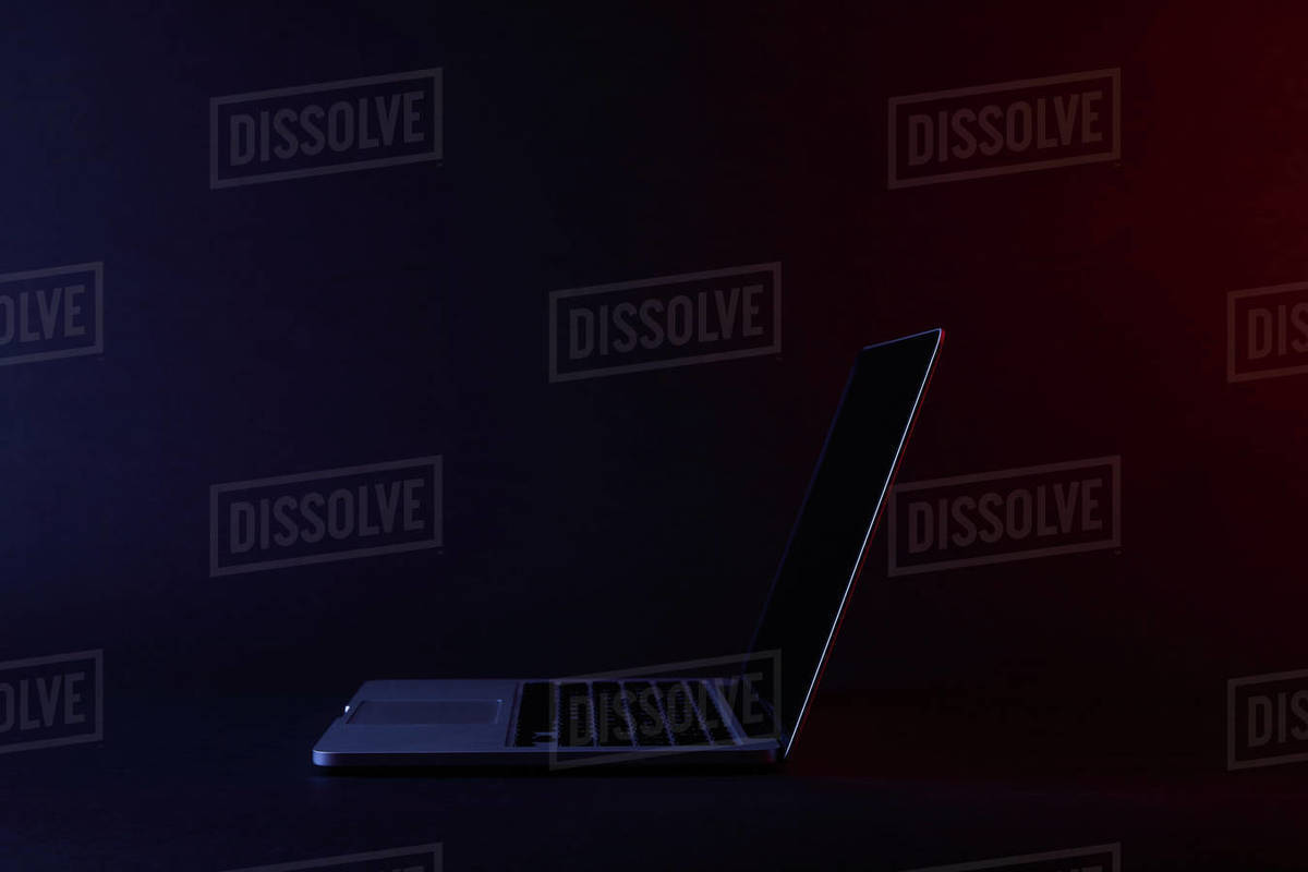 one open laptop with reflecting screen on dark surface - Royalty-free ...