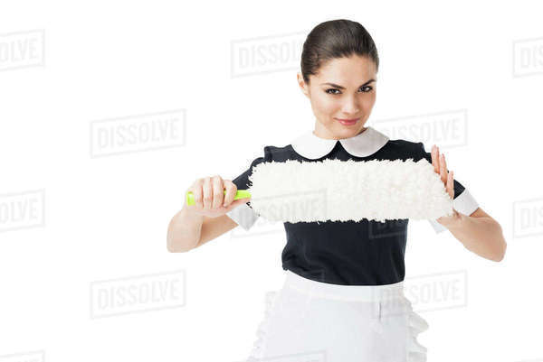 Professional maid in uniform holding duster isolated on white - Royalty ...