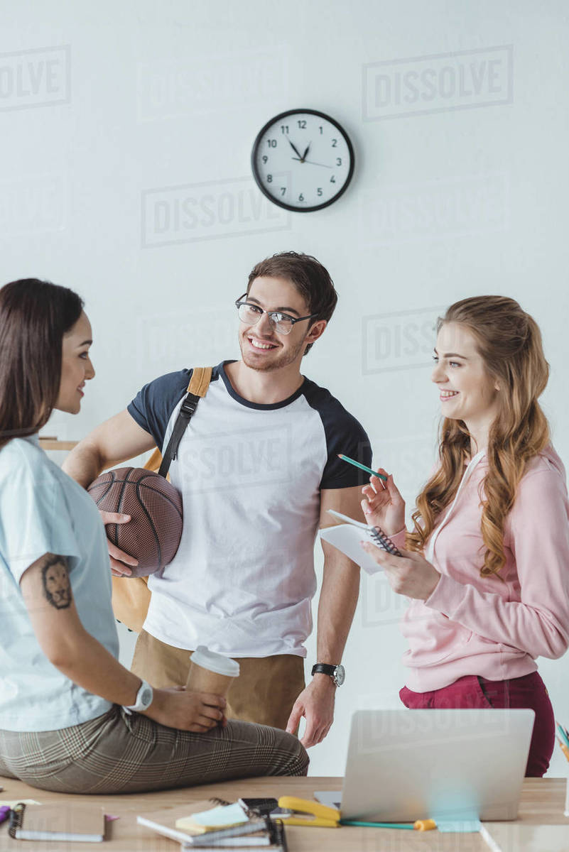 Young multicultural students talking together - Stock Photo - Dissolve
