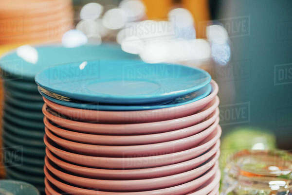 Close-up view of stacked clean blue and pink plates in kitchen - Stock ...