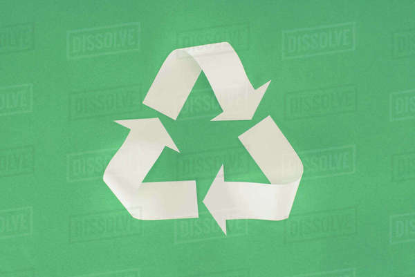 Top view of white arrows recycle sign on green - Stock Photo - Dissolve