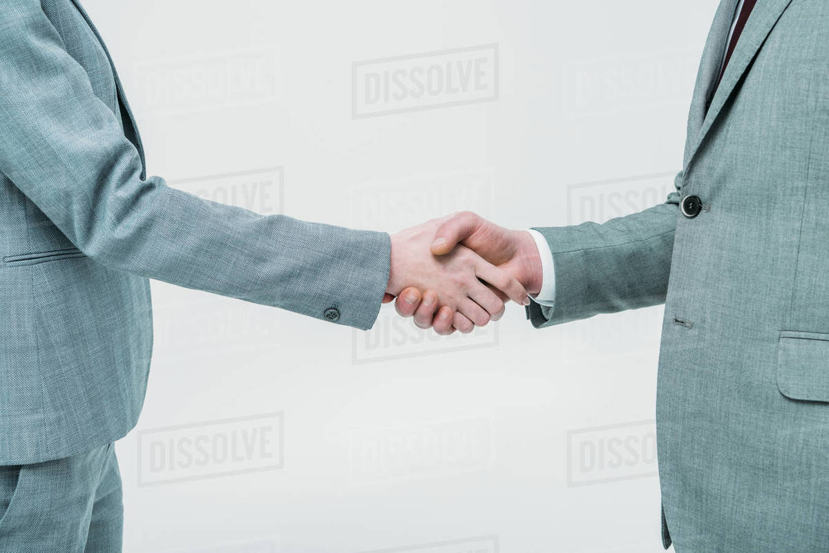 Cropped view of businesspeople in formal wear shaking hands, isolated ...