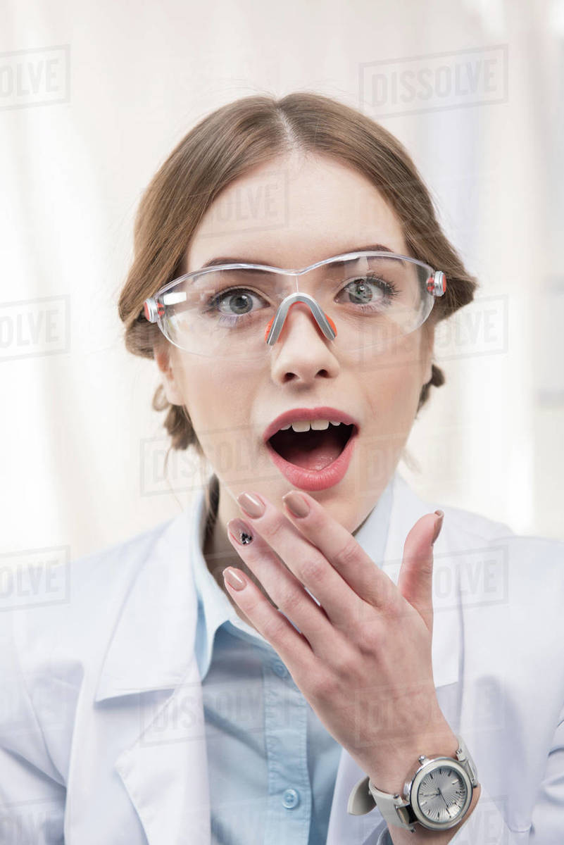 Surprised professional female scientist in protective eyewear - Royalty ...