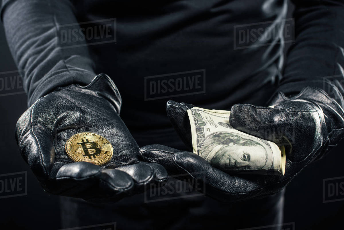Close-up view of dollars and bitcoin in hands of thief - Stock Photo ...