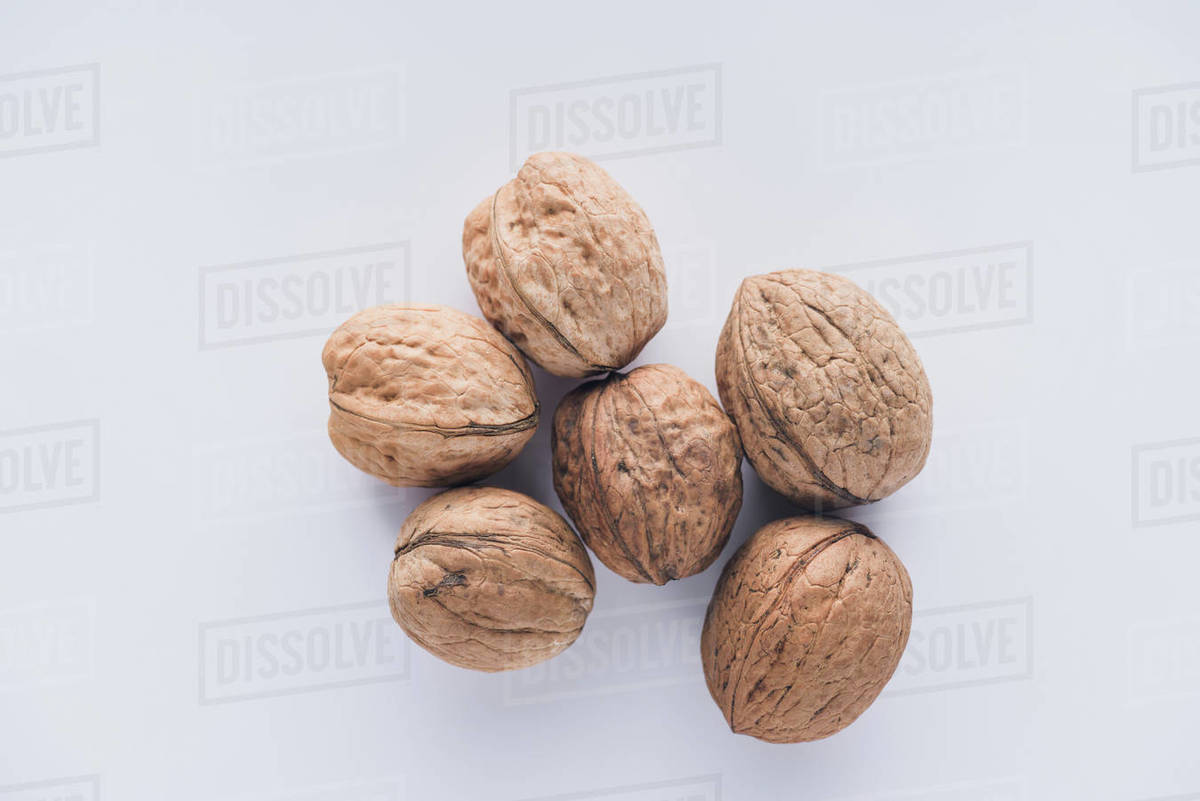 Top view of six walnuts on white surface - Royalty-free Stock Photo ...