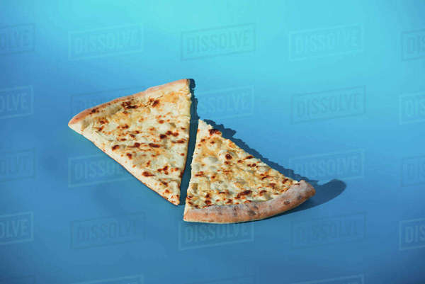 Close up view of pieces of cooked pizza isolated on blue - Stock Photo ...