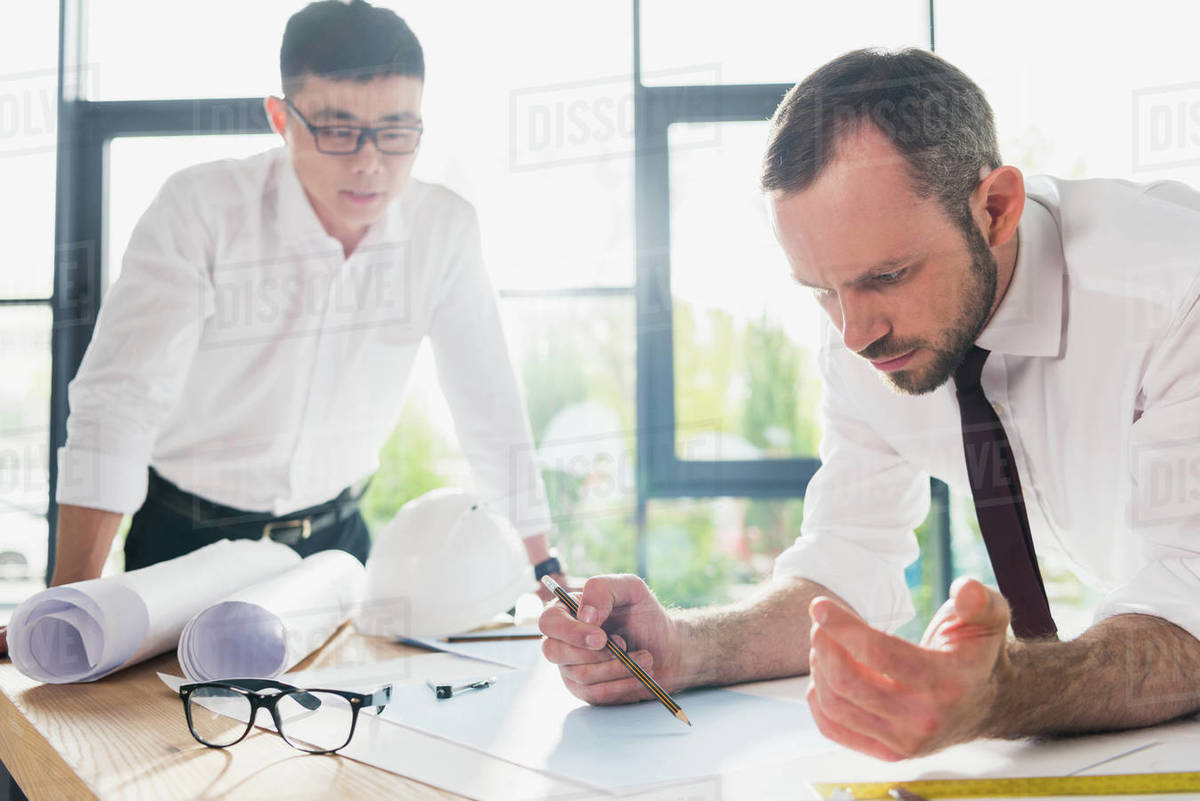 professional architects in formal wear working at modern office ...