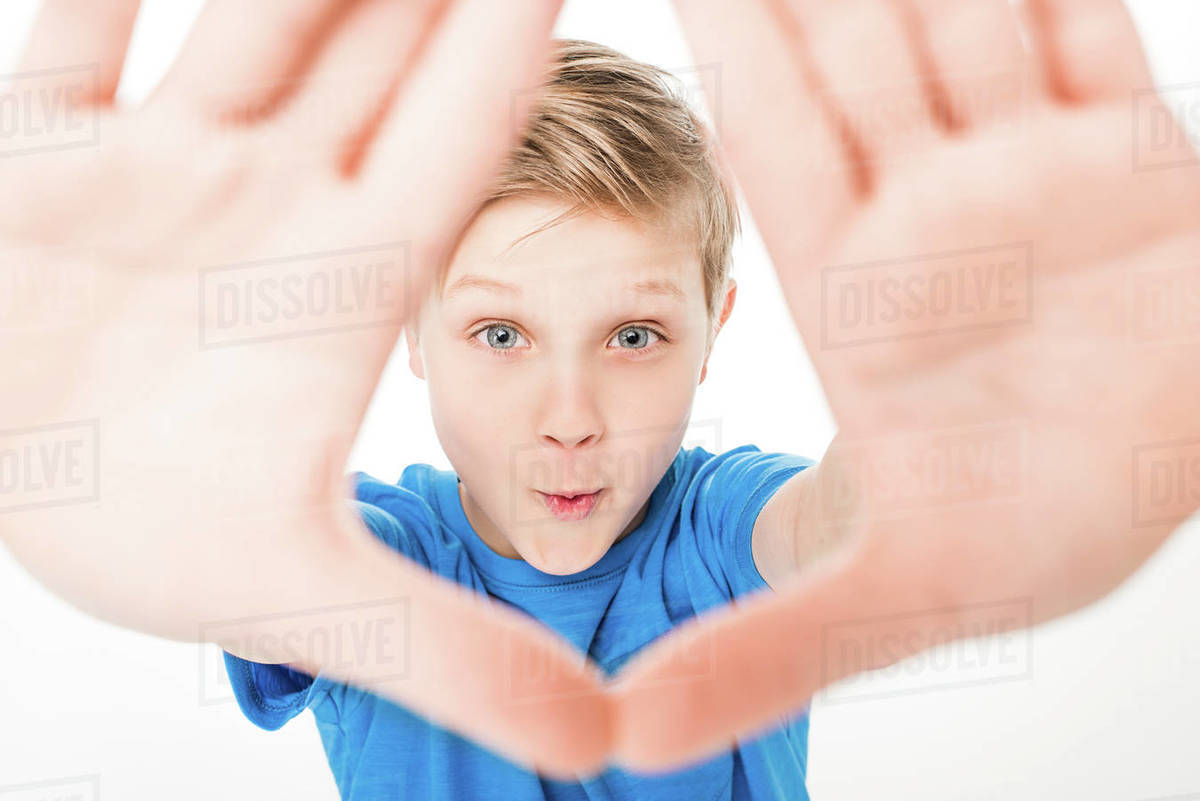 Cute little boy showing hands frame and smiling at camera isolated on ...
