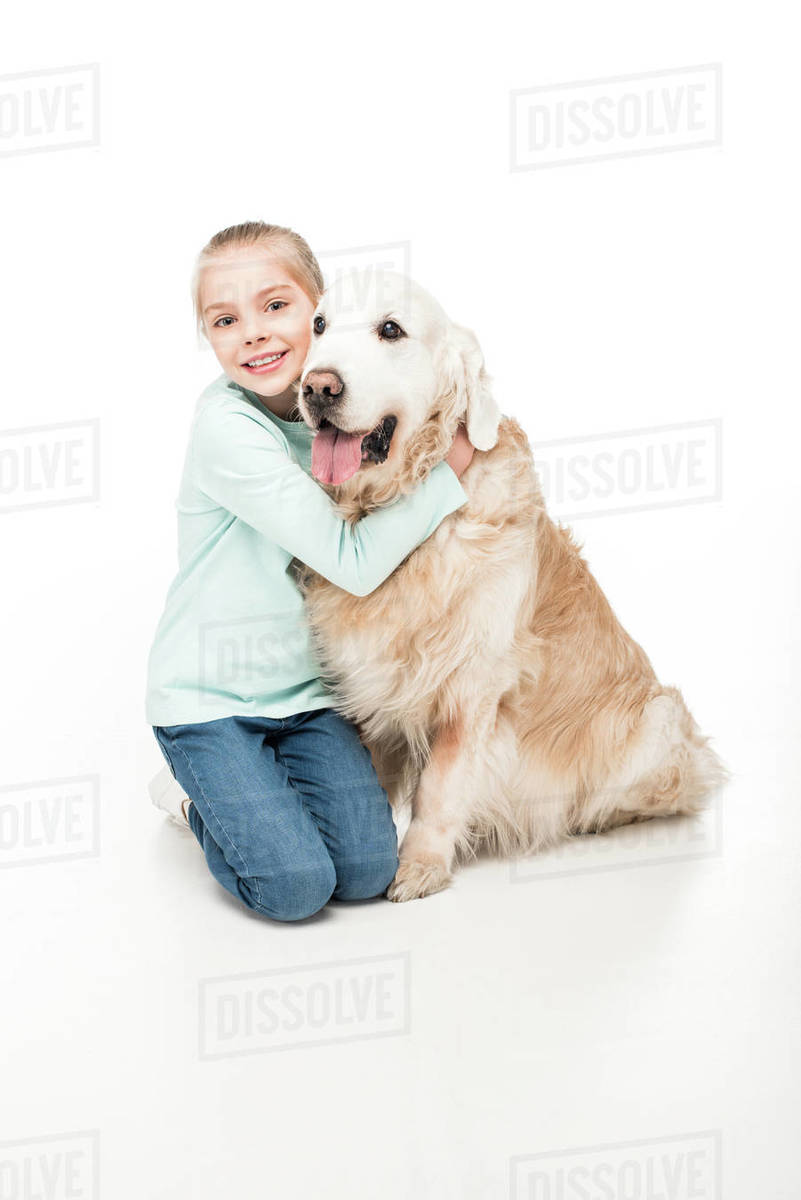 Beautiful little girl hugging dog and smiling at camera isolated on ...