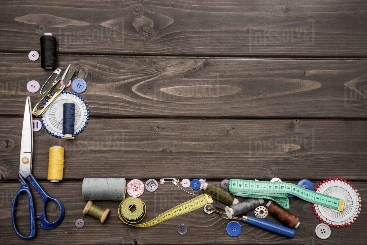 Top view of set of various sewing supplies on wooden surface - Royalty ...