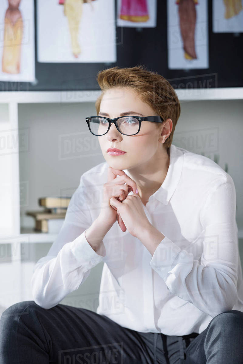 Close-up portrait of attractive thoughtful fashion designer - Royalty ...