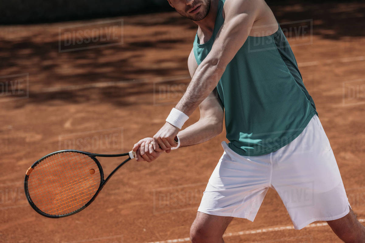 Cropped shot of tennis player making hit with racket - Royalty-free ...